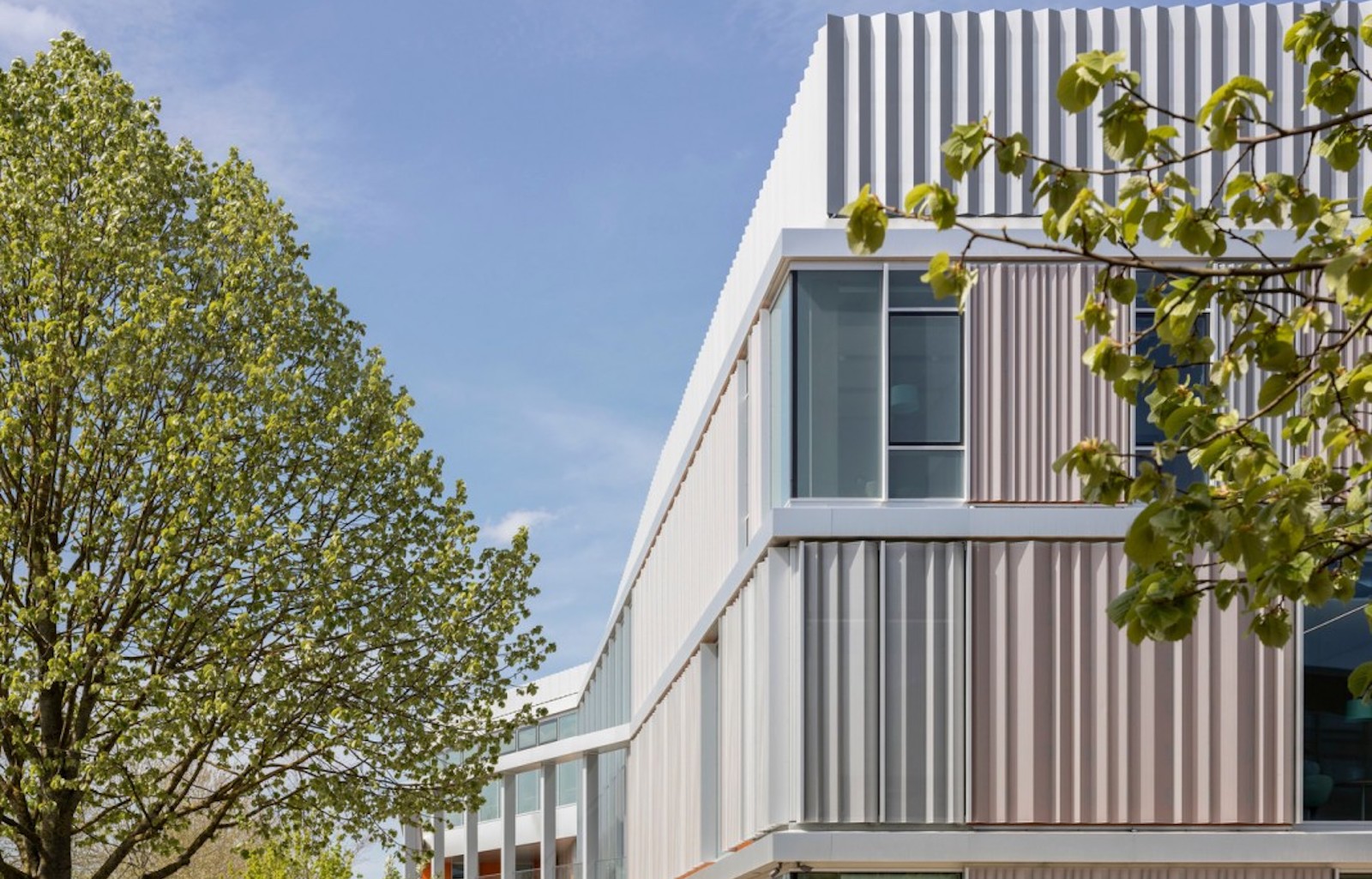 Perforated Aluminum Façade Reflects Scenery During the Day and Glows at ...